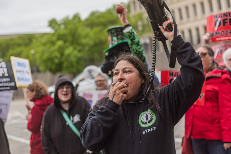 Protesters gather outside Barrett’s Lansing office after budget bill ...